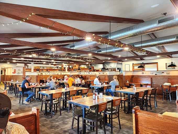 Exposed beams and string lights create an atmosphere that's equal parts rustic charm and modern comfort for your dining pleasure.