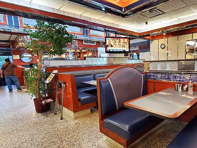 Step inside and you're greeted by warm wood paneling, navy blue booths, and that unmistakable diner energy that says "stay awhile."