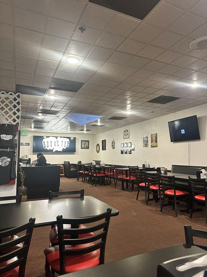 Simple tables, red chairs, and a glowing BBQ4LIFE sign create the perfect no-frills atmosphere. Who needs fancy when you've got flavor?