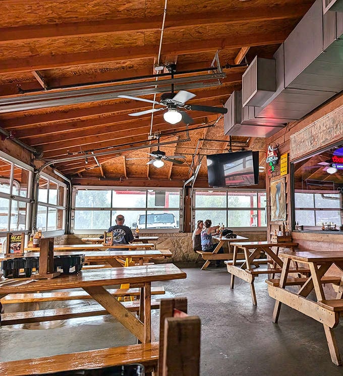 Picnic tables under exposed wooden beams create that perfect "focus-on-the-food" atmosphere. No white tablecloths needed when the meat's this good.