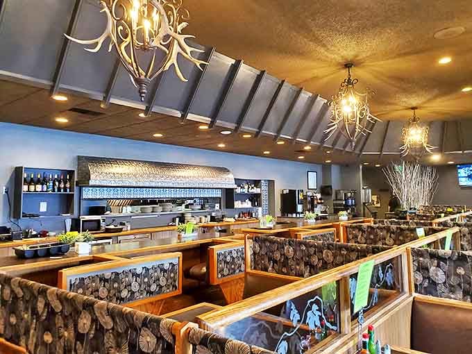 The interior feels like stepping into a mountain lodge where antler chandeliers cast a warm glow over wooden booths that have witnessed countless celebrations and comfort food comas.