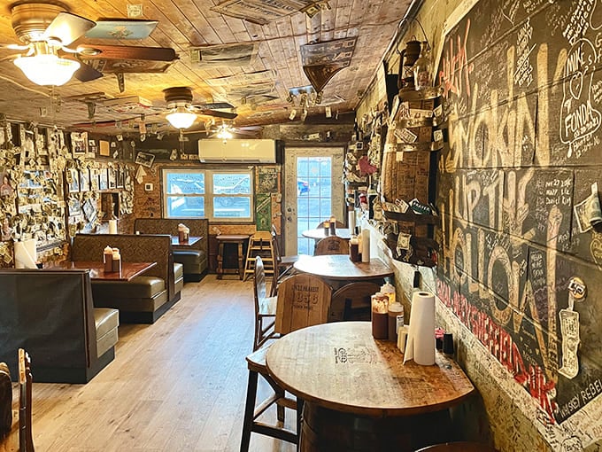 Inside, every inch tells a story. The walls and ceiling serve as a living guestbook where memories are preserved alongside the intoxicating aroma of smoked meats.