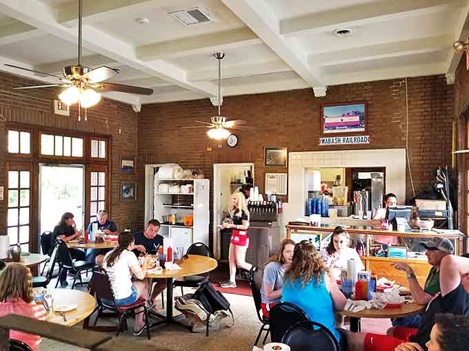 Step inside and you're transported to BBQ paradise. The exposed brick walls and ceiling fans create the perfect backdrop for the meat symphony about to unfold.