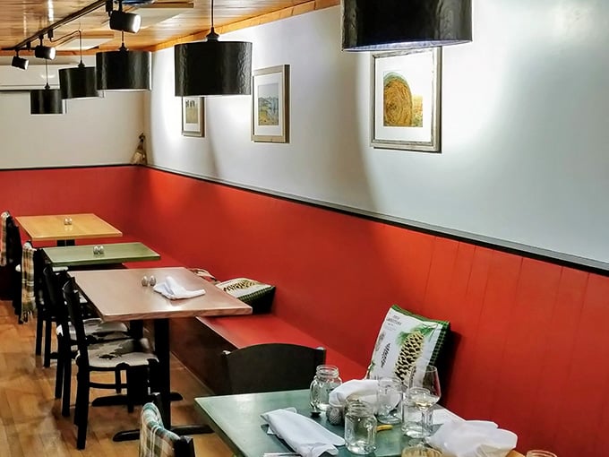 The red wainscoting and clean white walls create the perfect gallery space for the real art that arrives on your plate.