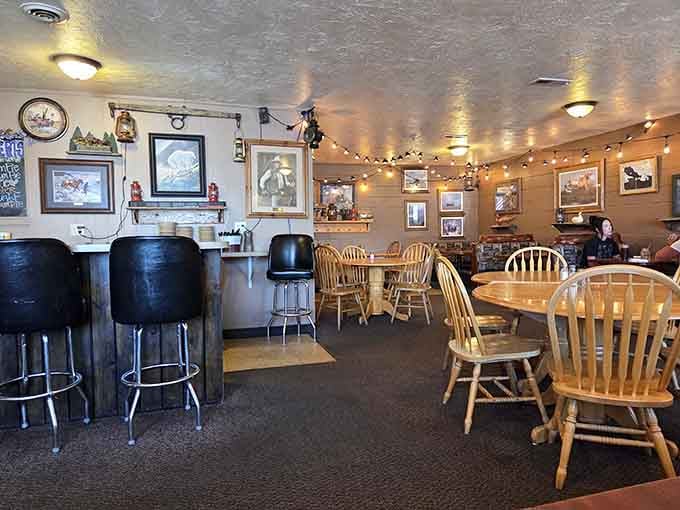 Wooden chairs, warm lighting, and local photographs create that rare dining atmosphere where everyone feels like a regular on their first visit.