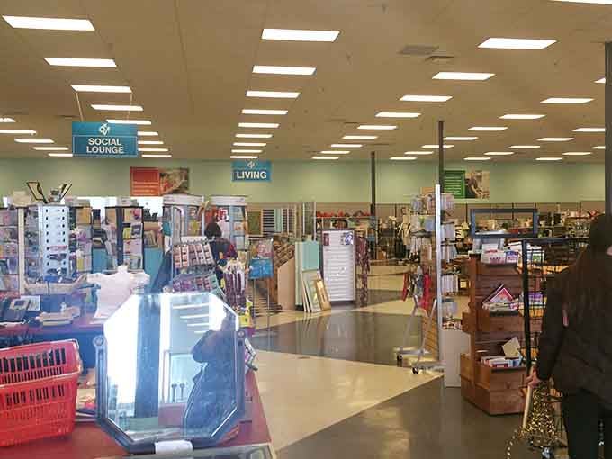 Department signs hovering above like retail guardian angels, guiding shoppers through this organized chaos of secondhand wonders.