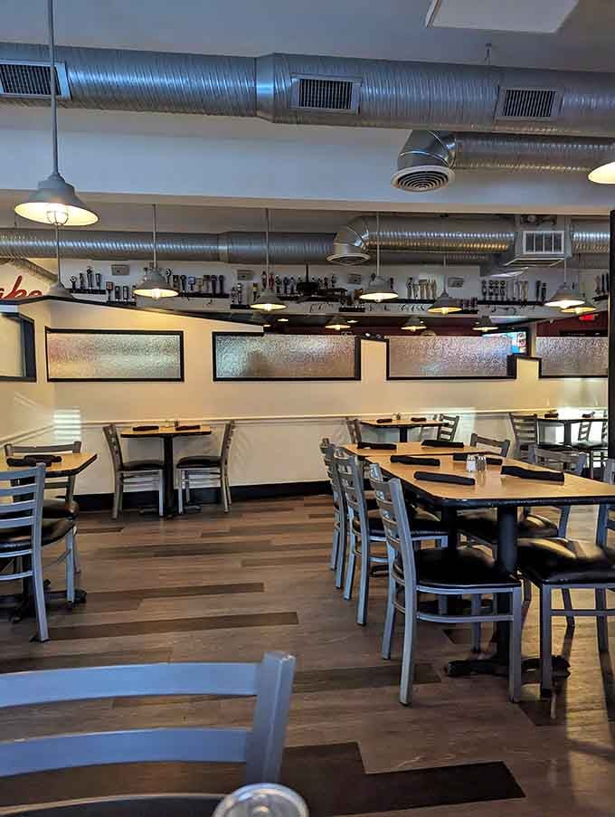 Industrial-chic meets cozy comfort in this dining room where exposed ductwork watches over wooden tables as patrons dive into Dover's most talked-about comfort food.