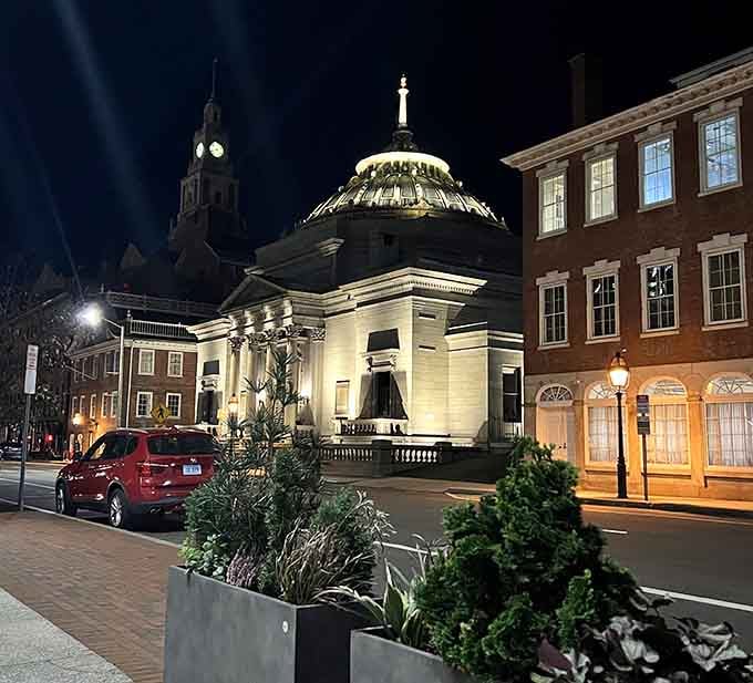 Downtown Coventry at night transforms into a Norman Rockwell painting come to life, with historic architecture bathed in golden light.