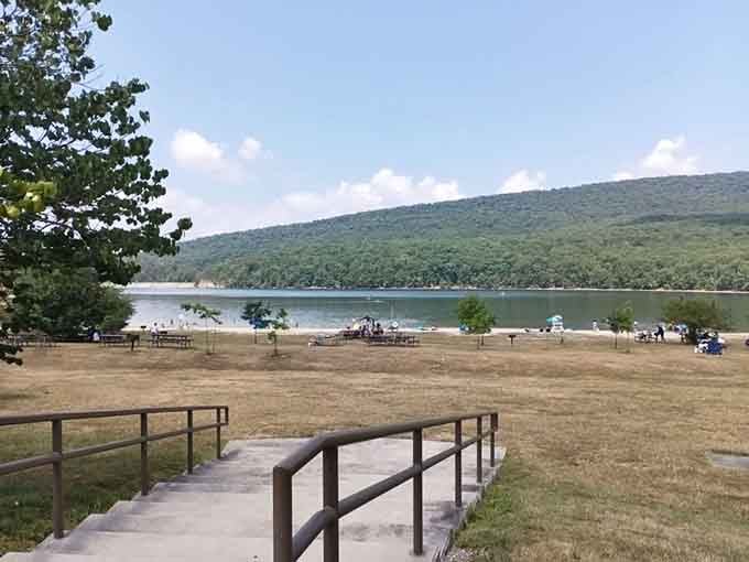 The beach at Rocky Gap invites you in like an old friend, with mountains standing guard over swimmers enjoying nature's perfect pool.