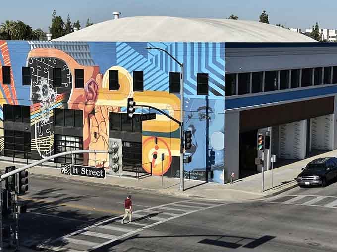 Street art explodes across building facades in bold geometric patterns that would make Mondrian jealous.