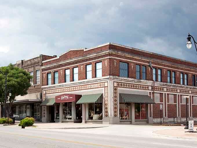 Classic brick architecture with striped awnings creates that timeless Main Street America feeling you thought was gone forever.