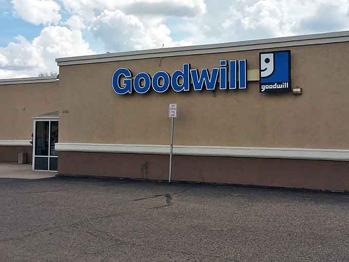 Goodwill's iconic blue sign beckons bargain hunters like a lighthouse guiding ships to treasure-filled shores.