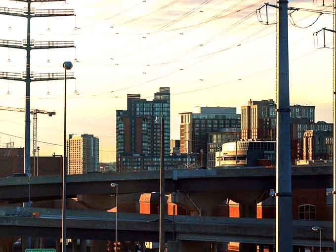 Golden hour transforms the urban skyline into something almost magical, painting concrete and steel with warm light.