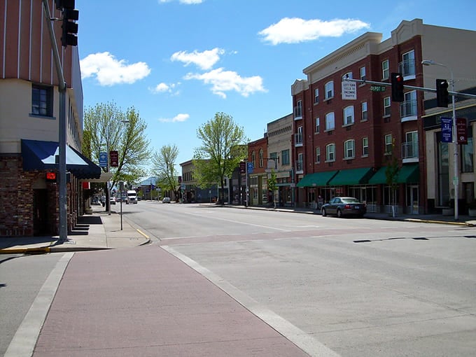 Wide streets and brick buildings under blue skies create a scene straight from a vintage postcard.