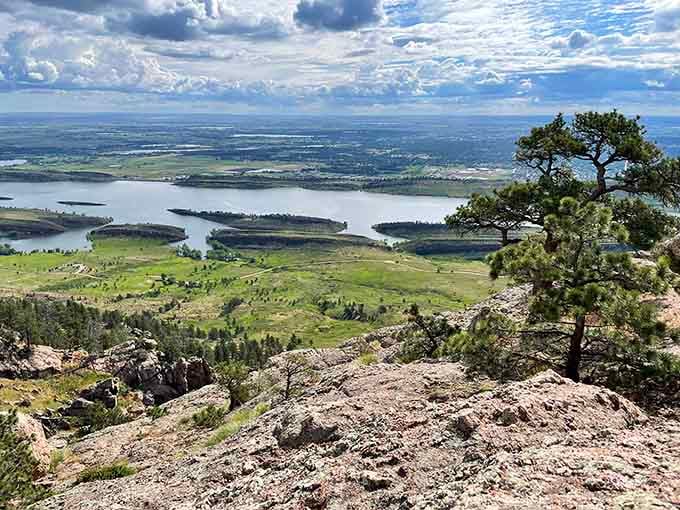 From this rocky perch, the reservoir spreads below like a blue mirror reflecting endless sky and possibility.