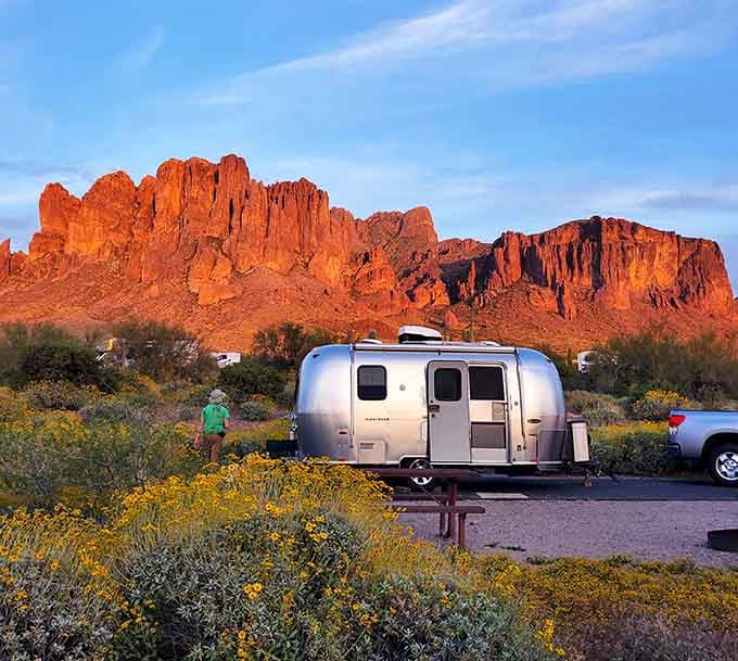 Golden hour at the Superstitions turns your Airstream into a silver jewel against mountains that glow like embers.