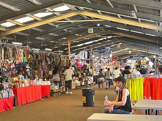 Under the metal roof, shoppers browse treasures while that trusty fan keeps the summer heat at bay.