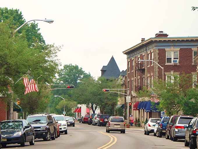 Tree-lined streets curve gently past historic buildings, creating the kind of neighborhood where every corner feels like home.