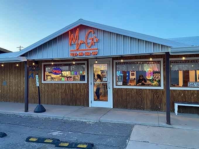 Mr. G's glowing neon sign lights up Route 66 like a beacon for hungry travelers. This wooden roadside gem screams "pizza pit stop!"