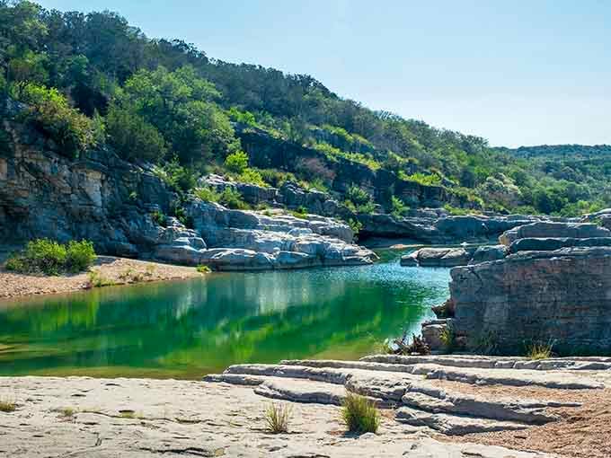 Emerald water pools between limestone shelves, creating nature's own lazy river without the inflatable tubes.