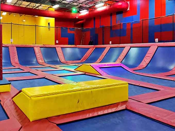 A sea of colorful trampolines stretches out before you, inviting bounces that would make astronauts jealous.