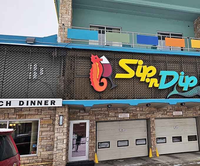 The Sip 'n Dip's colorful vintage sign promises underwater wonders that Vegas wouldn't dare attempt.