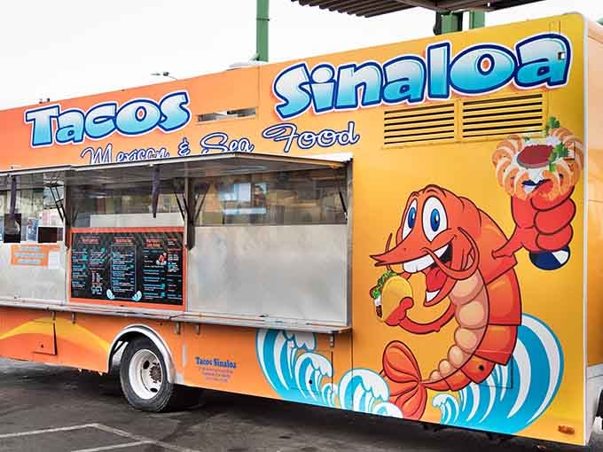Tacos Sinaloa's cheerful orange truck with its cartoon shrimp mascot – like finding the happiest food beacon in Oakland!