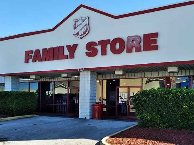 The Salvation Army's iconic shield welcomes shoppers to their Family Store. Red accents pop against the clean white building.