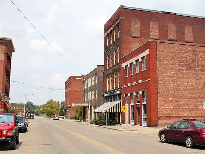 Red brick warehouses stand proud along quiet streets where history and affordability shake hands like old friends.