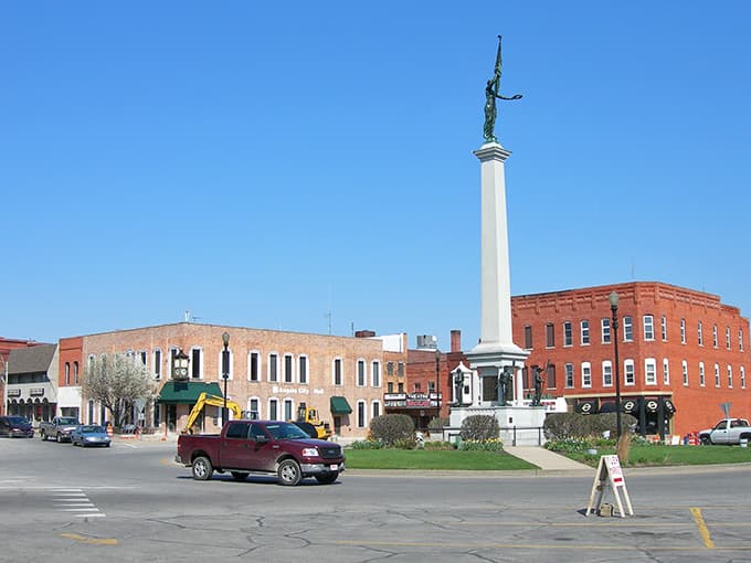 The town square monument reaches skyward, a beacon reminding everyone that community matters more than keeping up appearances.