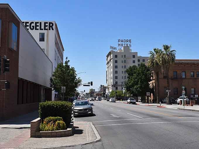 The Padre Hotel sign stands tall against blue skies, a beacon of classic California architecture and style.