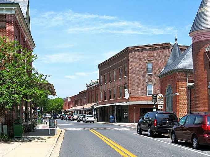 Classic American architecture lines this peaceful street where church steeples still define the skyline instead of cell towers.
