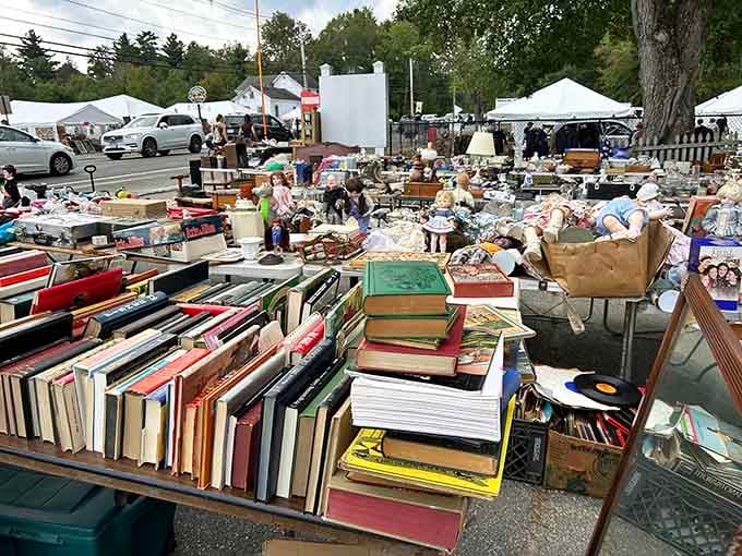 Books stacked higher than your grandkids tower over vintage finds, creating a literary lover's outdoor paradise here.
