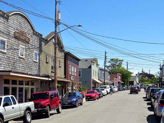 Weathered wooden buildings stand shoulder to shoulder like old friends sharing stories along this timeless waterfront avenue.