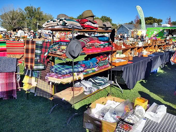 Colorful blankets stacked high like a rainbow caught mid-fall&mdash;someone's grandmother would absolutely approve of this display.