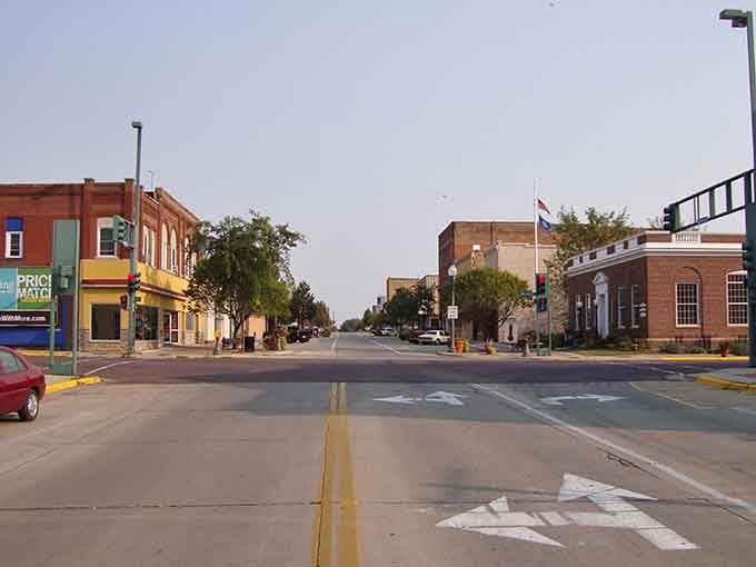 Sunlight bathes Fairmont's historic buildings where locals gather for coffee that costs less than big city parking meters.