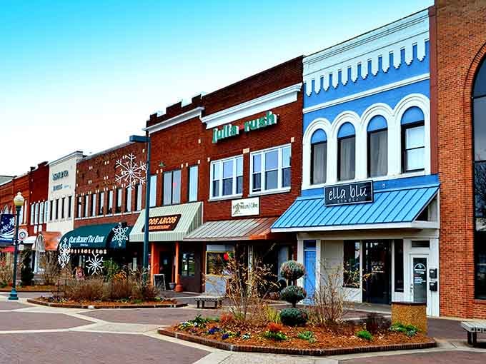 Bright blue awnings pop against red brick, creating a downtown streetscape that's pure small-town charm.