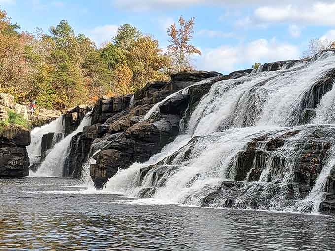 Autumn transforms this broad cascade into a postcard moment, with rushing water framed by fall's golden palette.