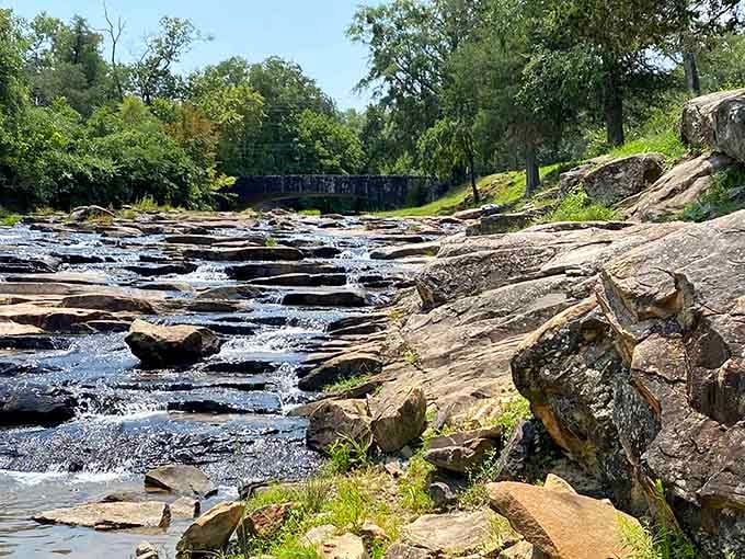 The spring flows over layered stone creating nature's own staircase, each step perfectly carved by time.