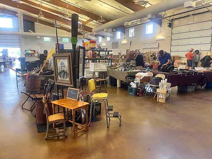 Inside, the industrial space transforms into a wonderland of antiques where every booth tells a different story from decades past.
