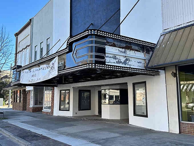 That vintage theater marquee beckons like a time machine to simpler Saturday nights.