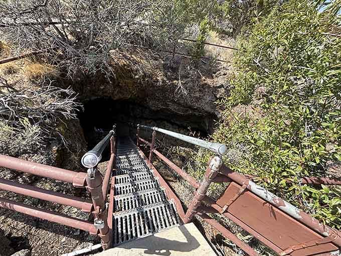 Looking down into adventure: metal stairs descend into volcanic darkness where ancient lava once flowed like rivers.