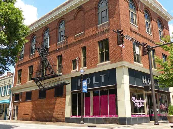 Historic brick buildings with modern pink accents show that old towns can embrace new energy without losing character.
