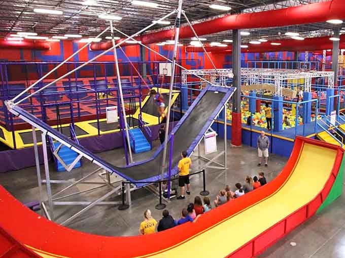 The obstacle course looms overhead like a playground designed by someone who never heard the word "impossible."