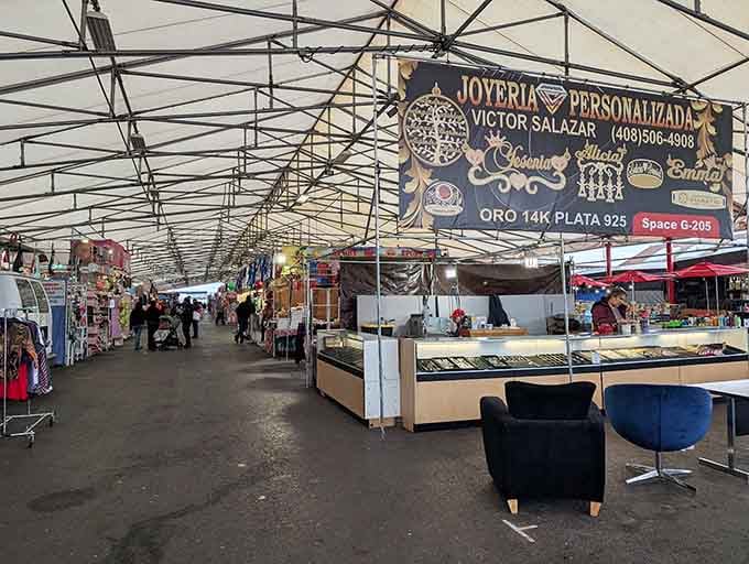 Indoor covered walkways create a comfortable shopping experience where personalized jewelry vendors display their sparkling wares under metal roofing.