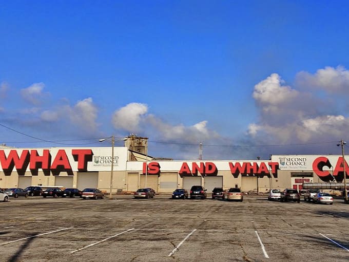 Those dramatic red letters against blue sky create a billboard effect that would make Madison Avenue jealous, honestly.