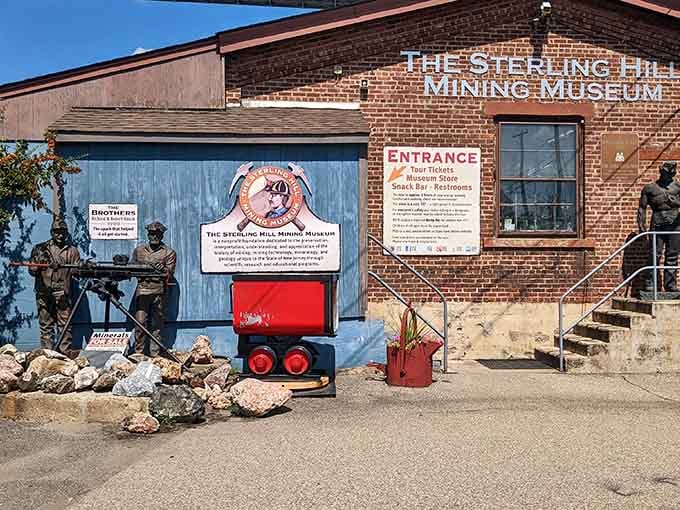 Mining carts and blue doors welcome curious explorers to a world where fluorescent minerals light up the darkness below.