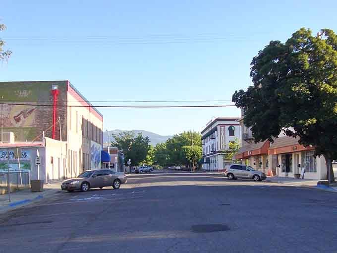 Mountains frame this quiet street where the pace of life moves slower and nobody minds one bit.