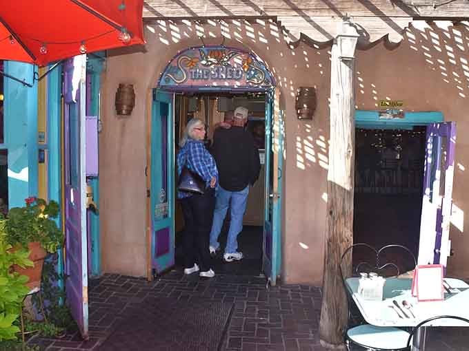 Hidden behind adobe walls, The Shed's vibrant entrance beckons hungry travelers. That turquoise doorway is basically a portal to chile heaven.