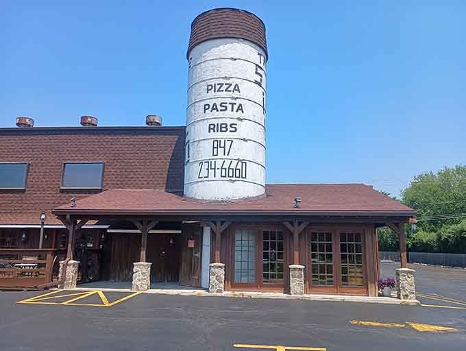 The menu painted right on the silo tells you everything: pizza, pasta, ribs, and one unforgettable phone number.